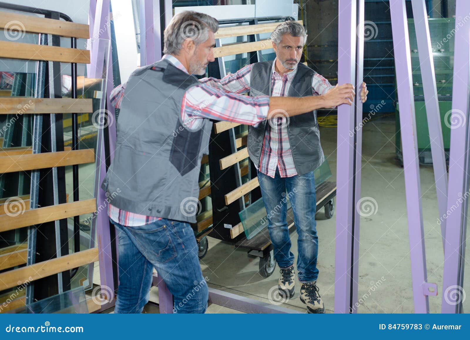 Worker holding wall mirror stock image. Image of building - 84759783