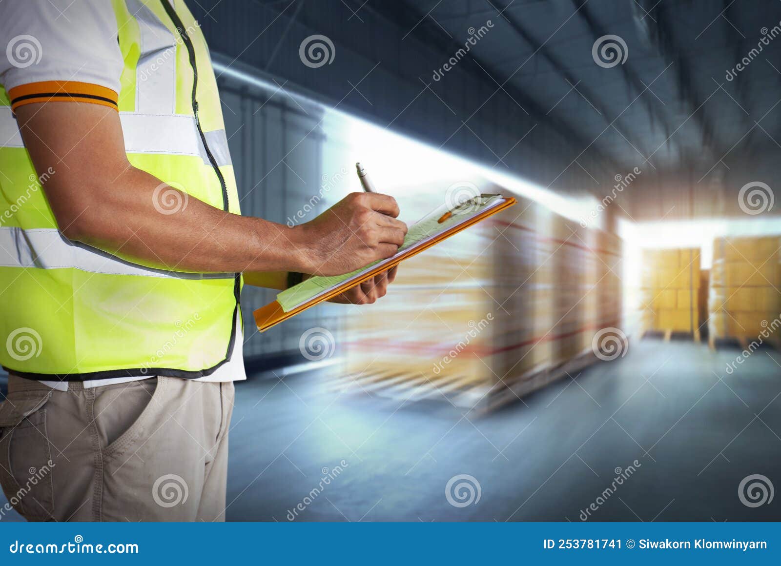 Worker Holds a Clipboard Checking the Loading of Cargo at Distribution ...