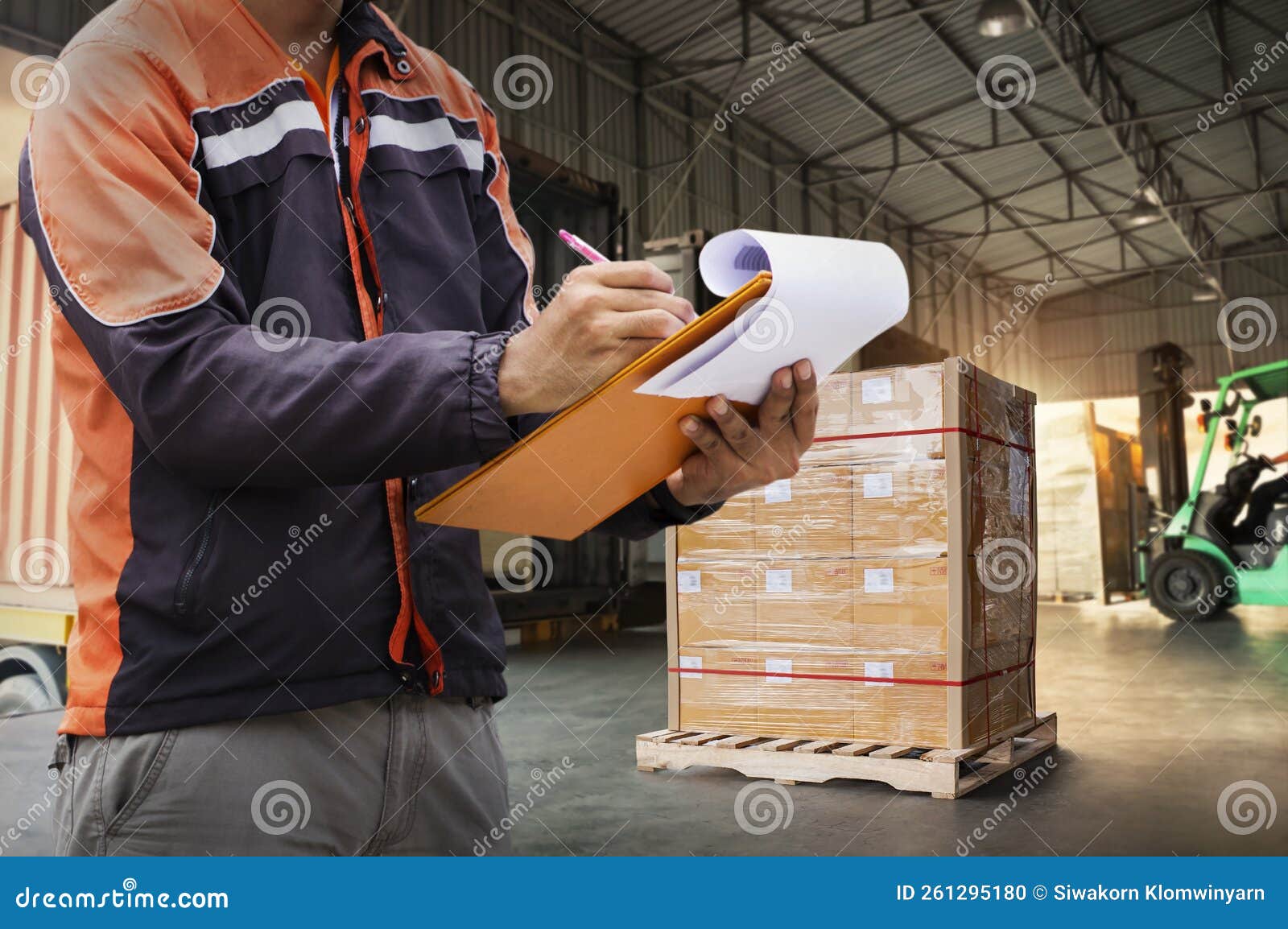 Worker Holds a Clipboard Checking the Loading Cargo Shipment at ...