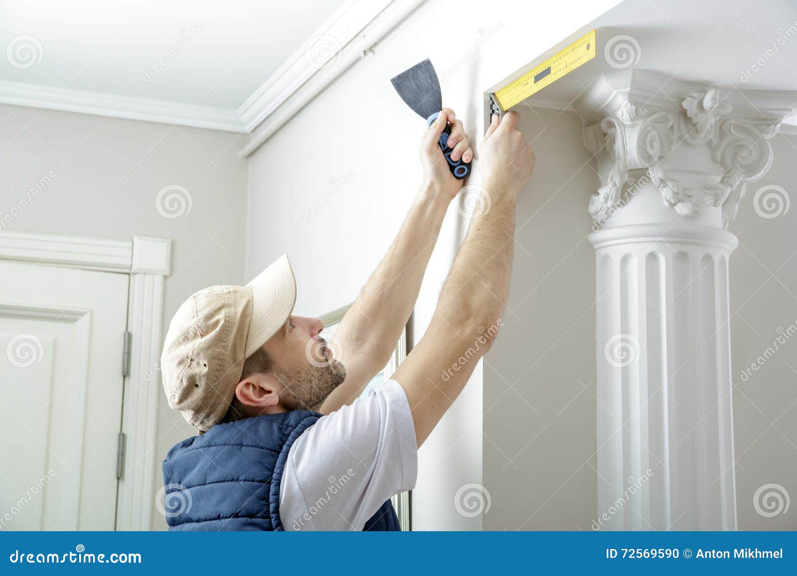 Worker Holds Putty Knife and Measures the Wall Corner Using Metal Angle ...