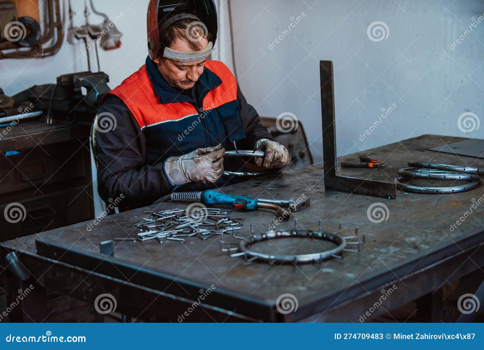 A Worker in an Industry Preparing Iron Structures for Welding Stock ...