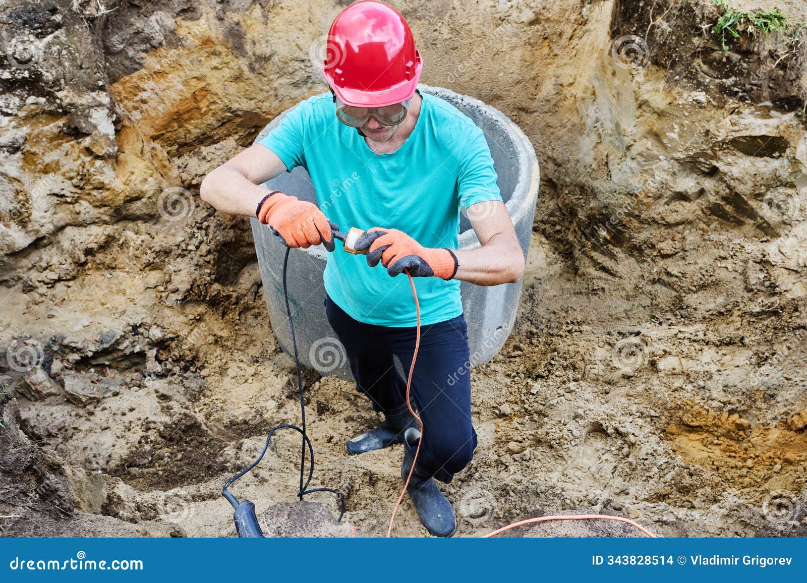 Plumber Inserts Bent Fitting Into Socket Of An Underground Sewer Inlet ...
