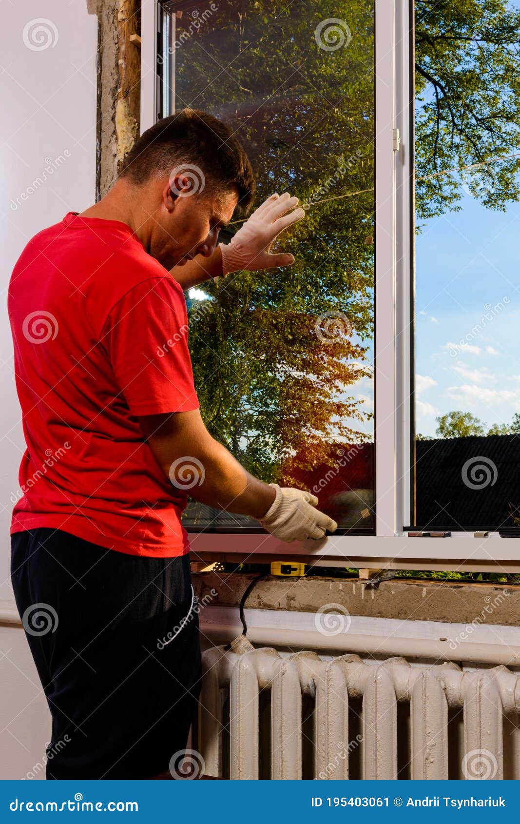 The Worker Inserts Glass into the Window Frame, Triple Glazing of the ...