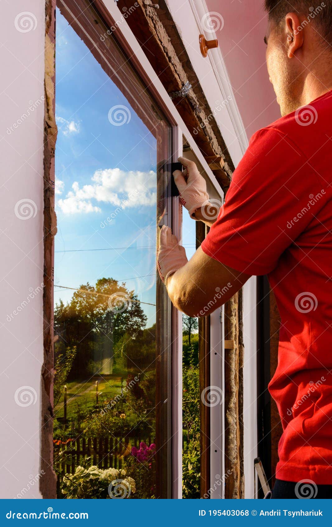 The Worker Inserts Glass into the Window Frame, Triple Glazing of the ...