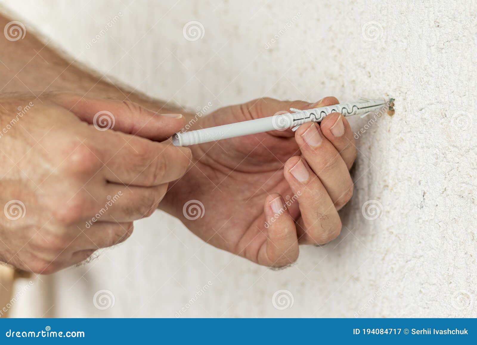 Worker Inserts An Electrical Appliance Plug Into An Extension Cord ...