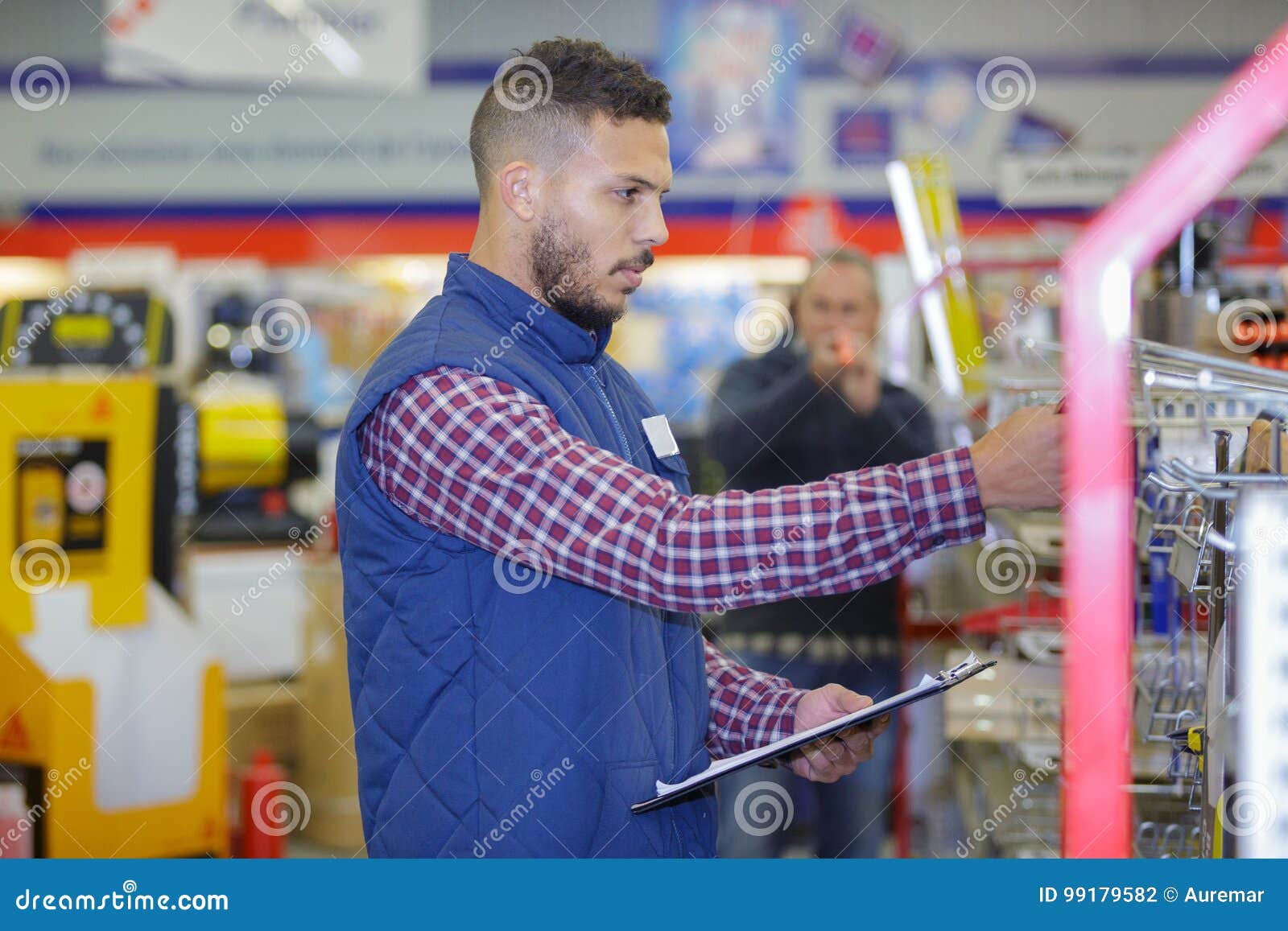 Worker Inspecting Product in Shop Stock Photo - Image of employee ...