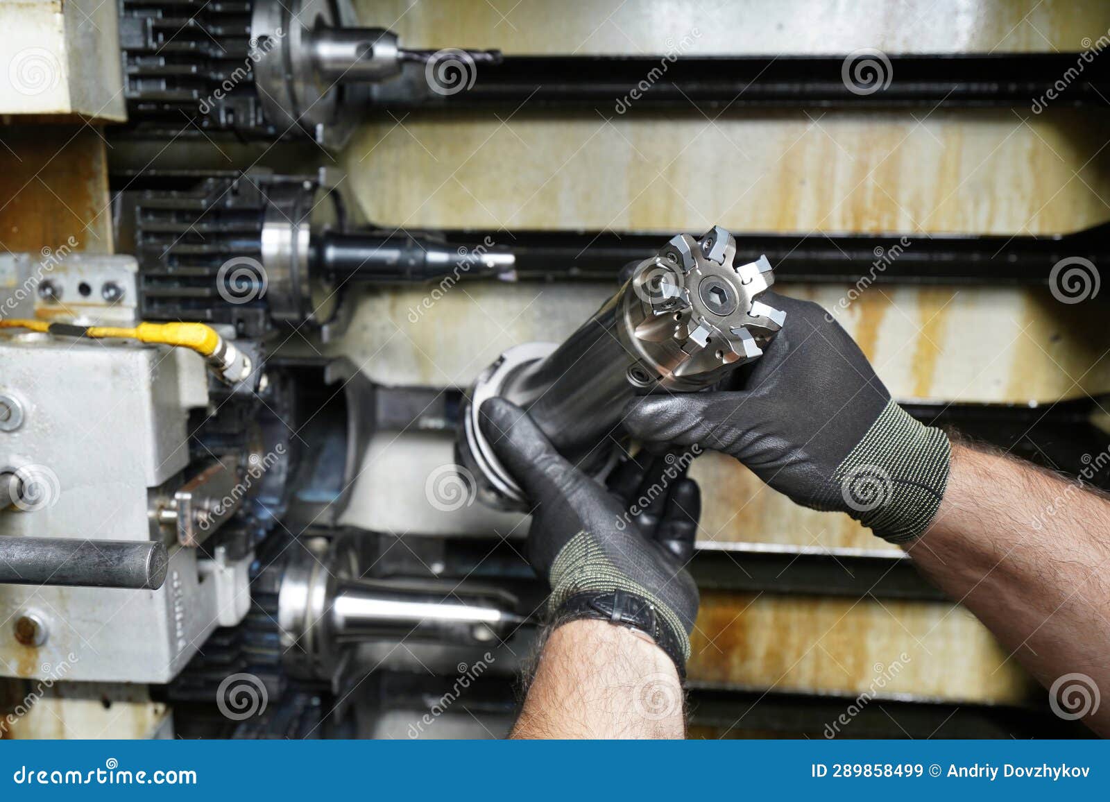A Worker Inspects and Changes a High-speed Cutter on a CNC Milling ...
