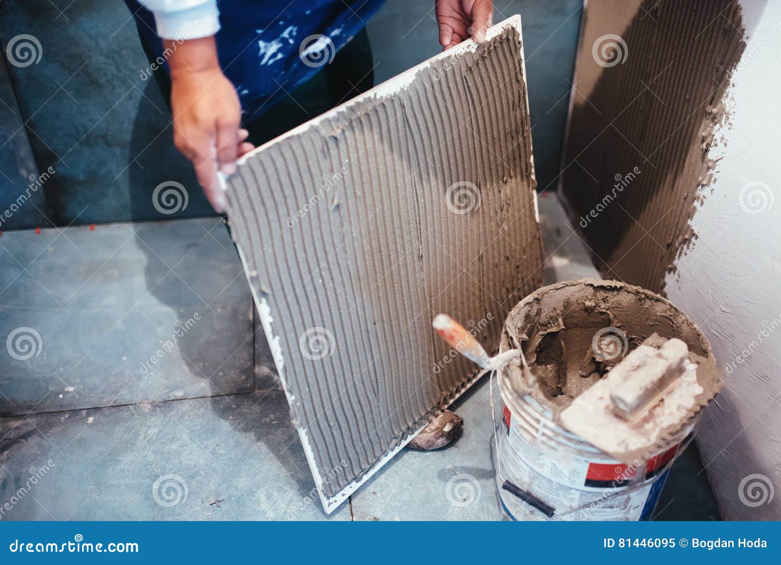 Worker Installing Bathroom Ceramic Floor Tiles, Adding Flexible Cement ...