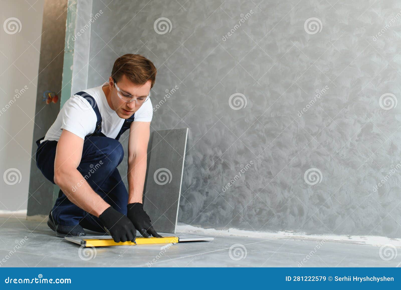 Worker Installing Ceramic Tile on Floor Near Wall. Stock Image - Image ...