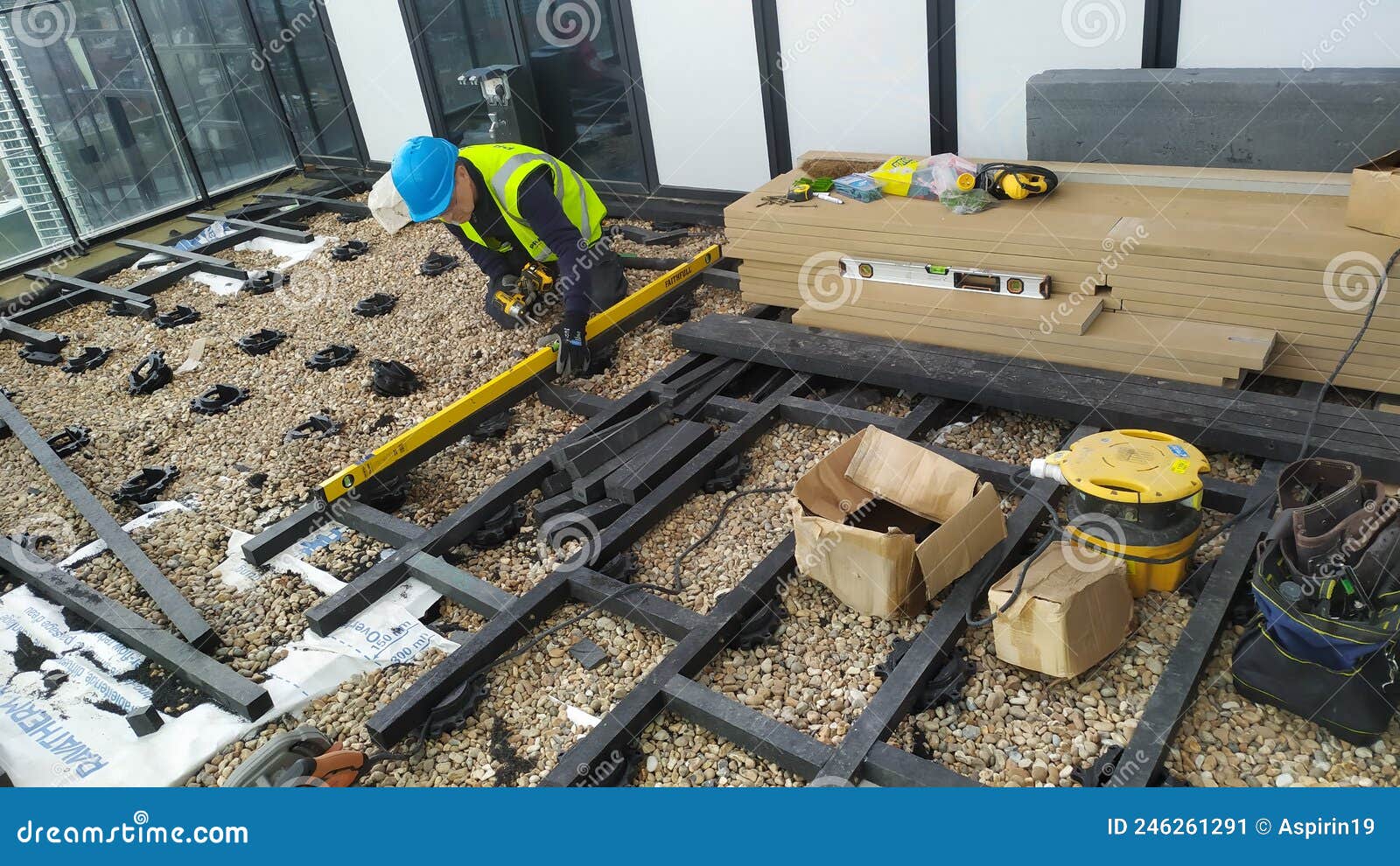 Worker Installing Decks on the Building Roof Using the Tools Editorial ...