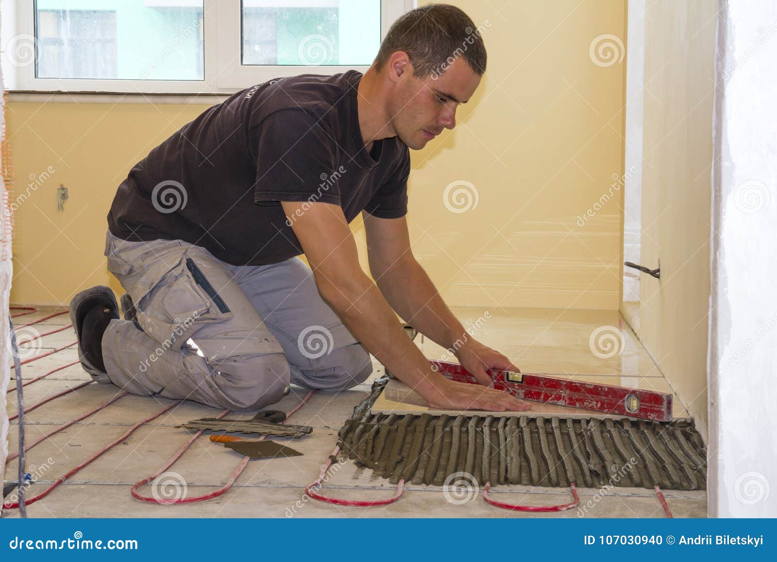 Worker Installing Floor Tiles. Ceramic Tiles and Tools for Tiler Stock ...