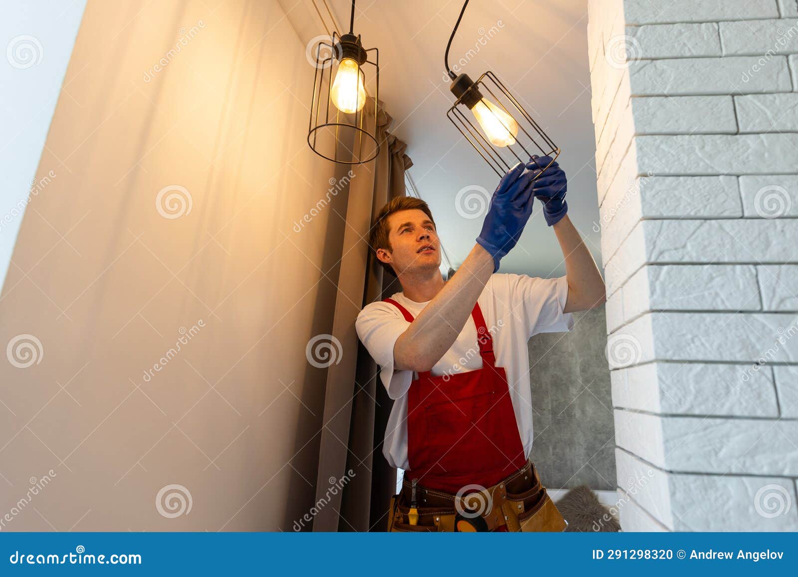 Worker Installing Lamp on Stretch Ceiling Indoors. Stock Photo - Image ...