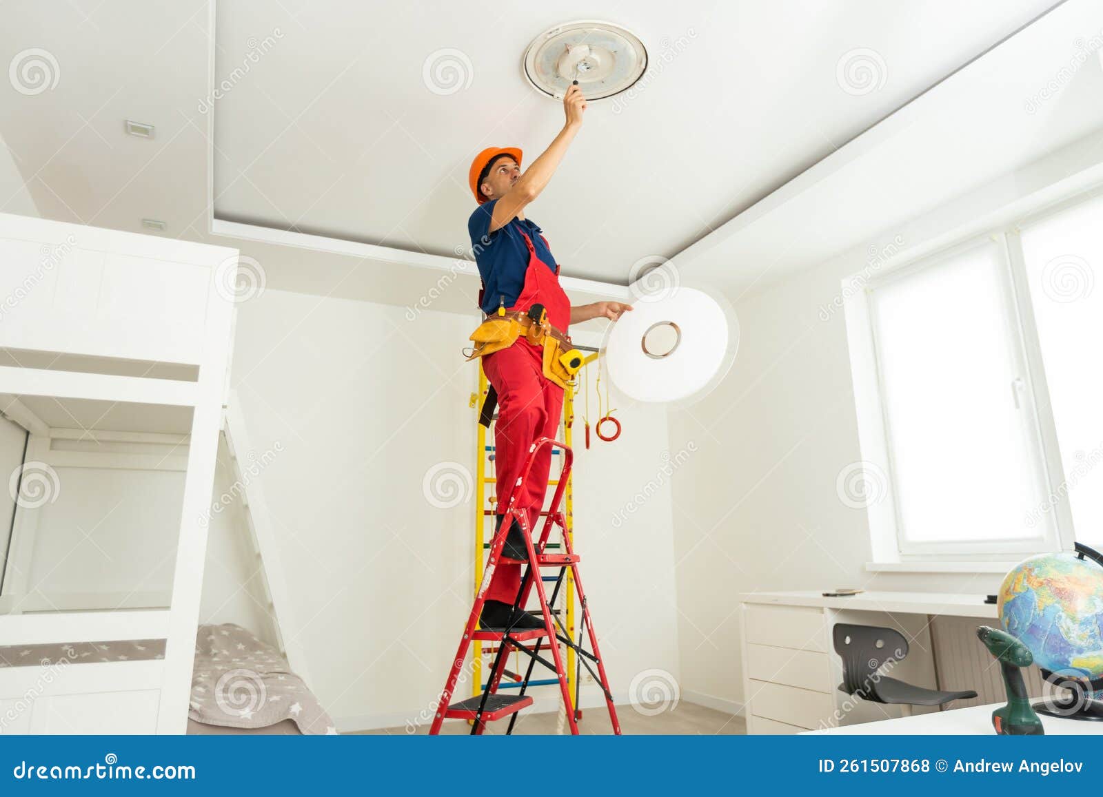 Worker Installing Lamp on Stretch Ceiling Indoors. Space for Text Stock ...