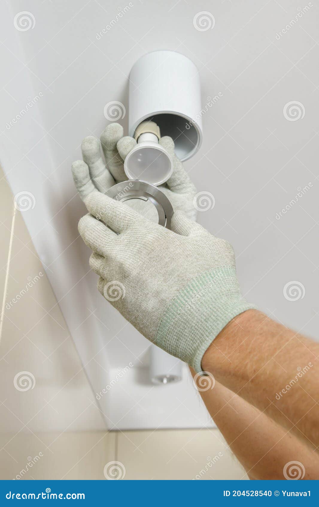 The Worker is Installing an LED Spotlight on the Ceiling Stock Photo ...
