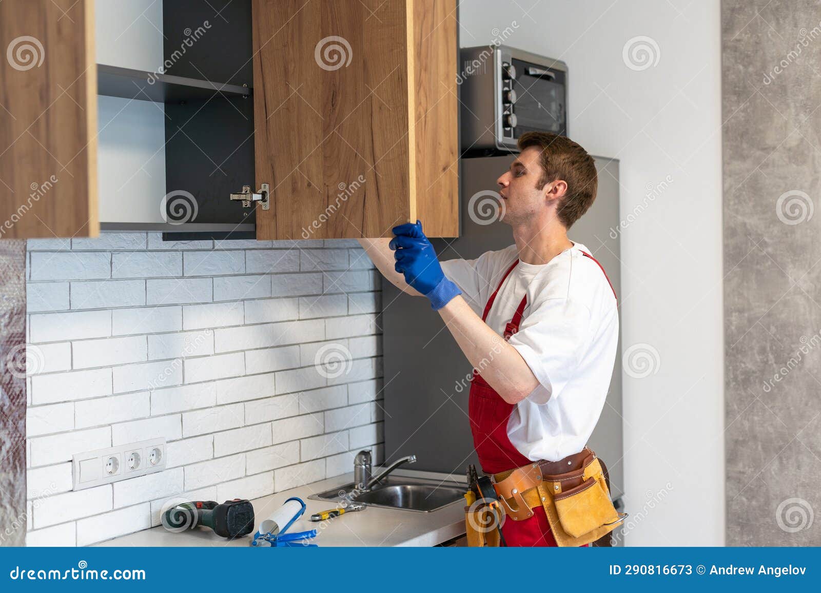 Worker Installing New Countertop in Modern Kitchen Stock Image - Image ...