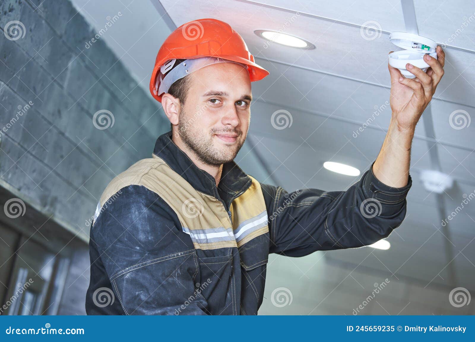 Worker Installing Smoke Detector On The Ceiling. Fire Alarm System ...