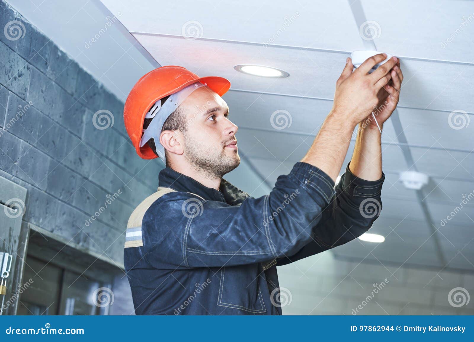 Worker Installing Smoke Detector on the Ceiling Stock Photo - Image of ...