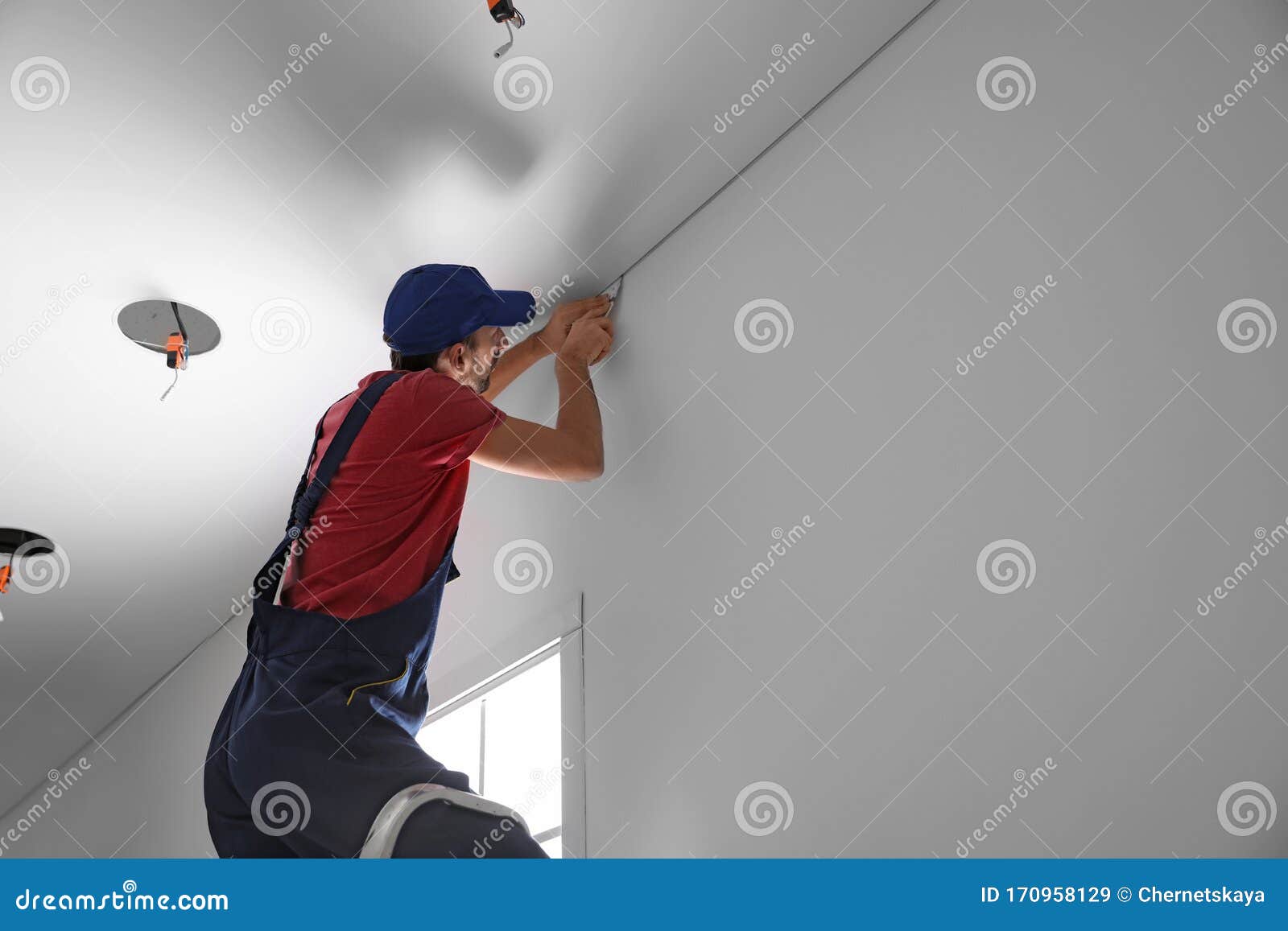 Worker Installing Stretch Ceiling in Empty Room Stock Image - Image of ...