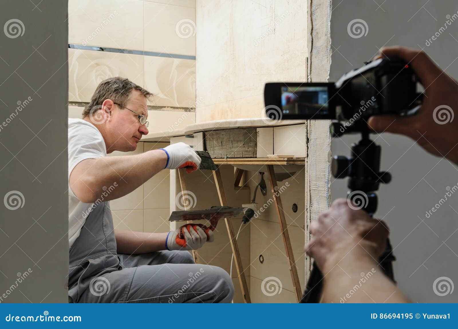 Worker Installs Ceramic Tiles. the Operator is Shooting this Pro Stock ...