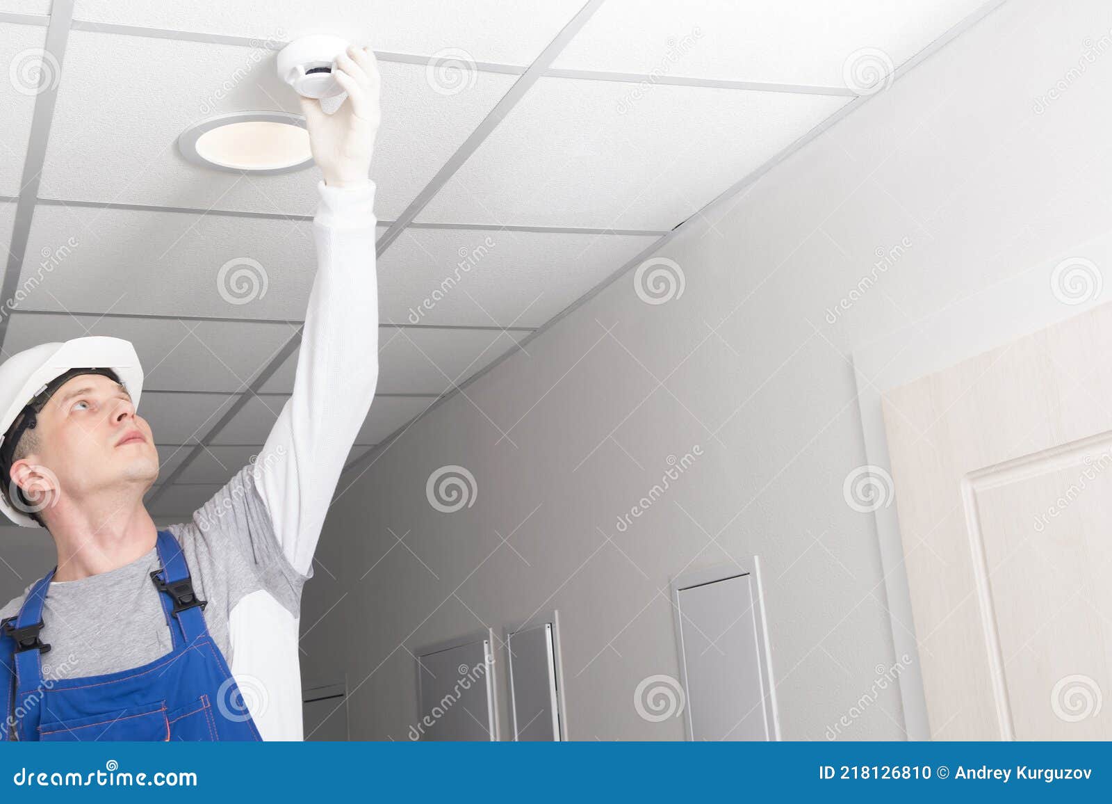 A Worker Installs a Fire Safety Sensor Stock Photo - Image of ...