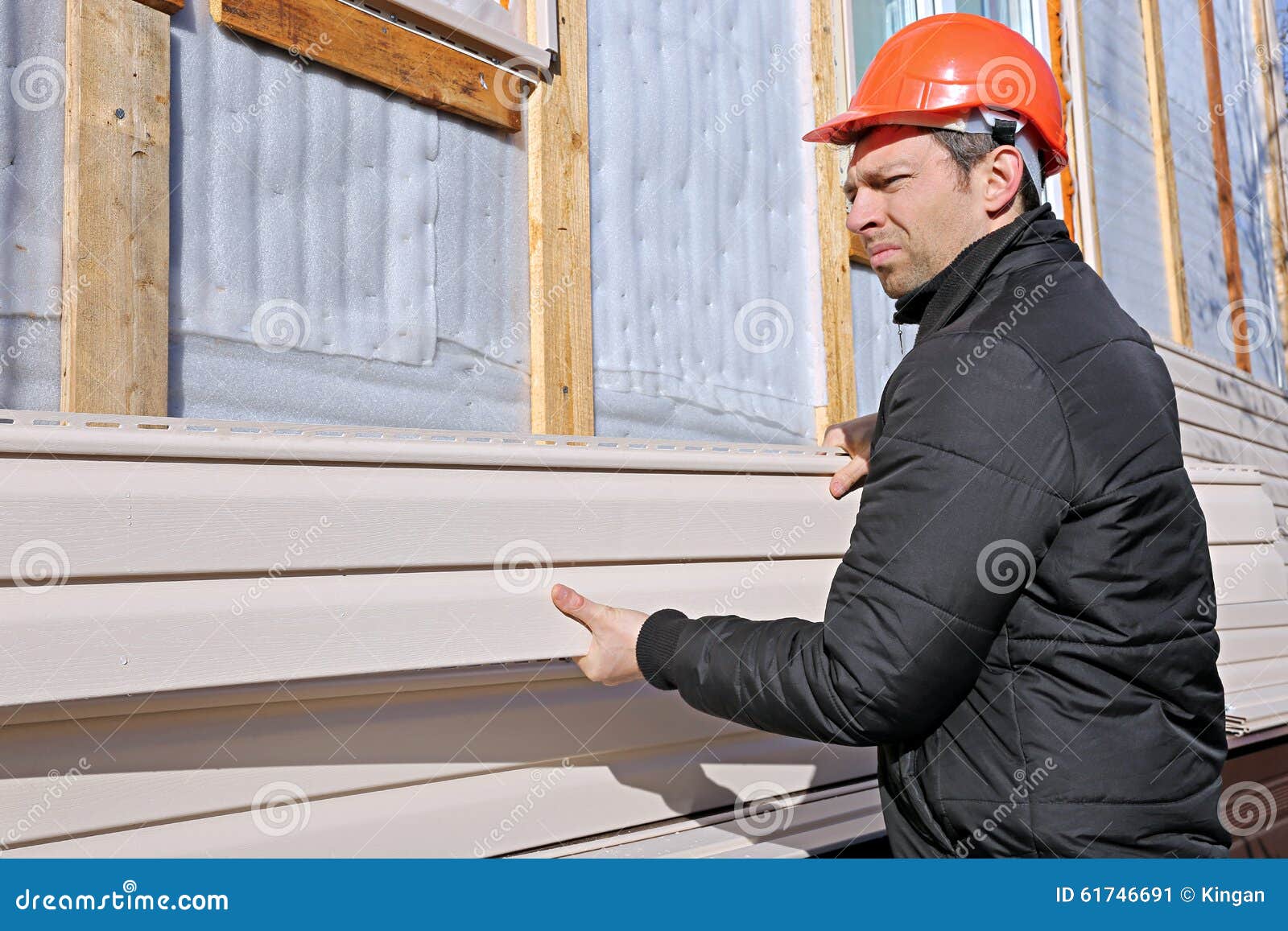 A Worker Installs Panels Beige Siding on the Facade Stock Image - Image ...