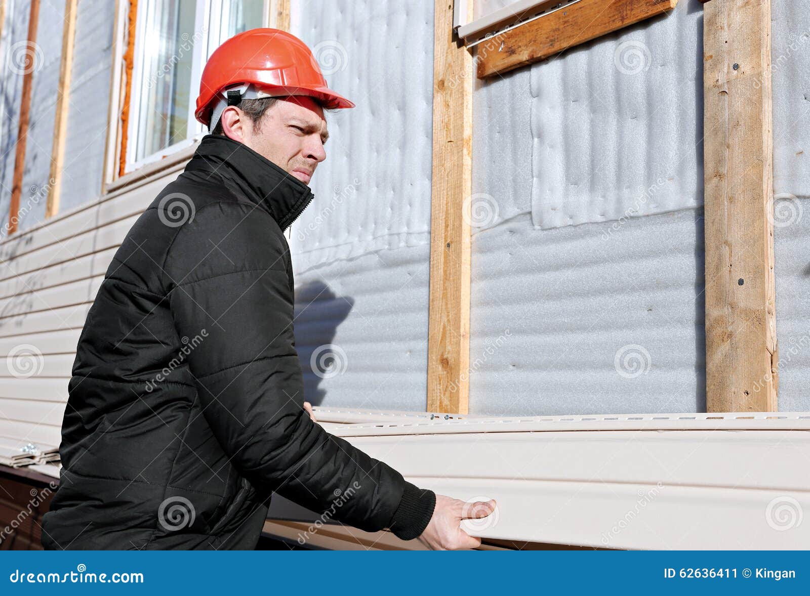 A Worker Installs Panels Beige Siding on the Facade Stock Image - Image ...