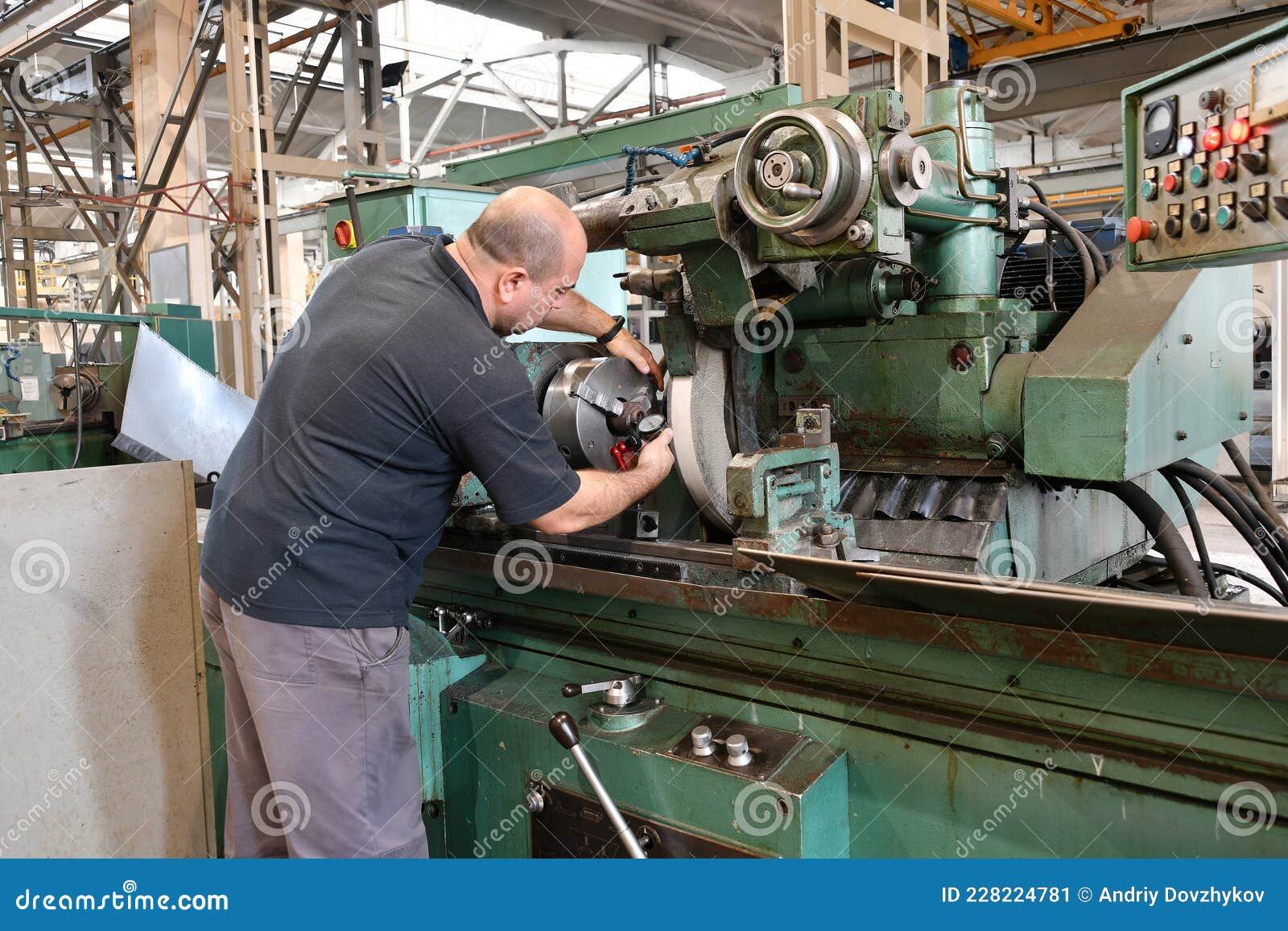 The Worker Installs the Part in the Chuck of the Grinding Machine for ...
