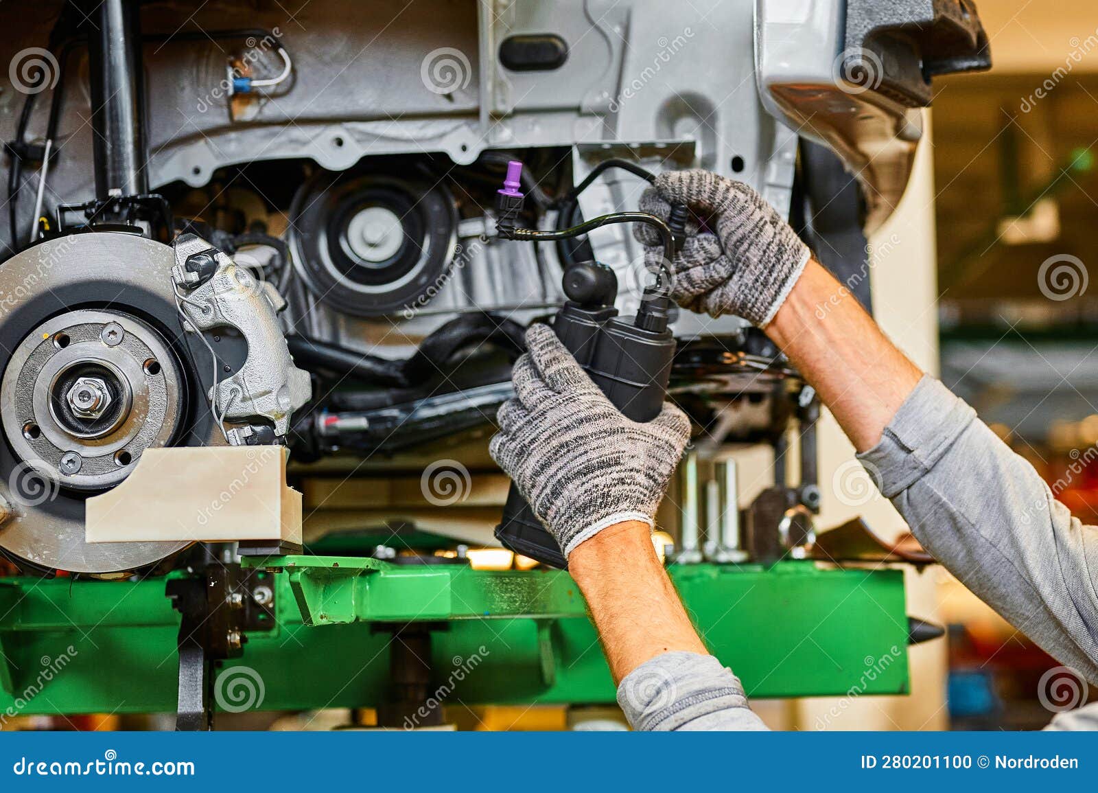 Worker Installs Plastic Box on Car Side in Workshop Stock Photo - Image ...