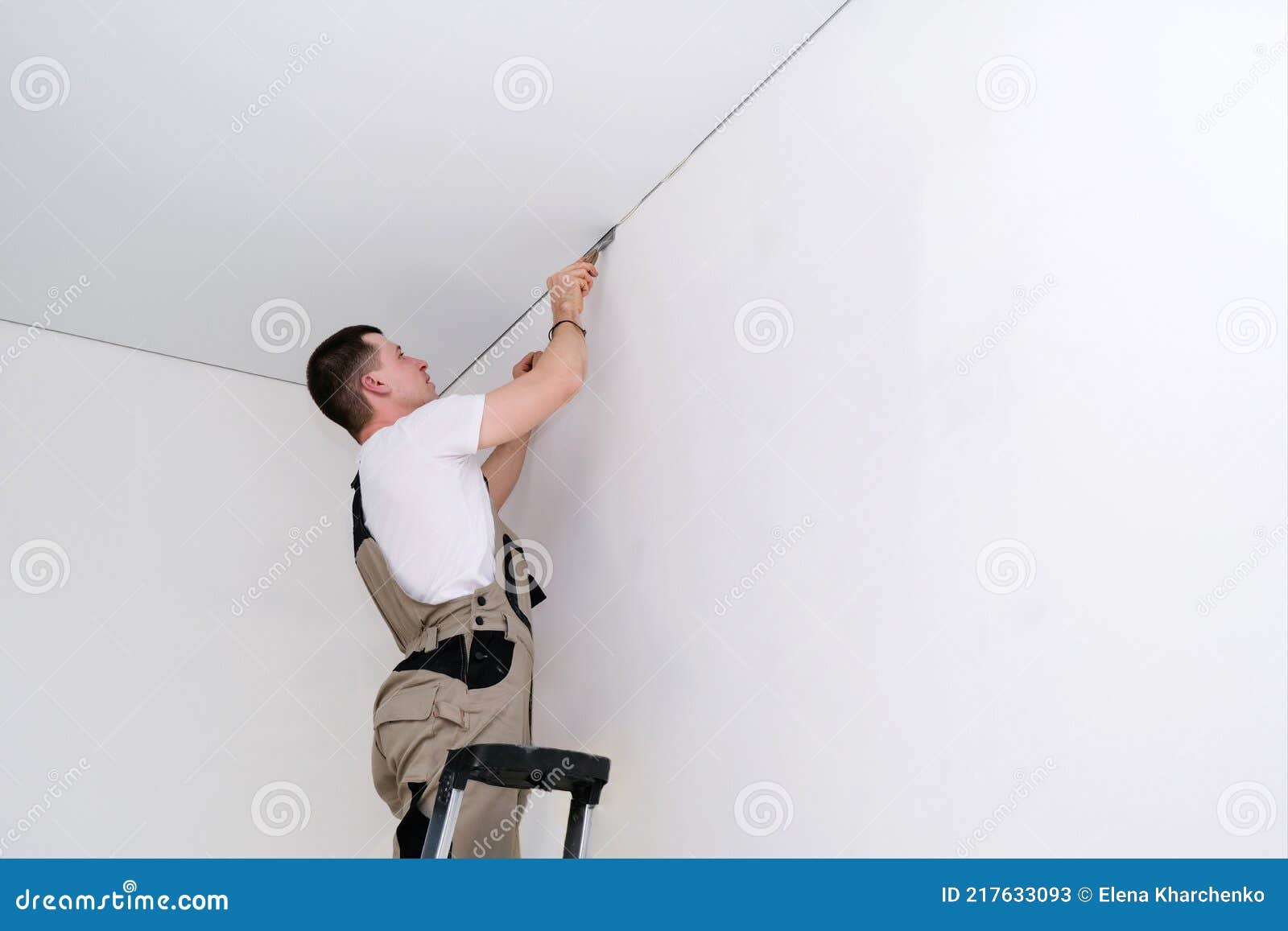 Worker Installs a Stretch Ceiling. Construction Stock Image - Image of ...