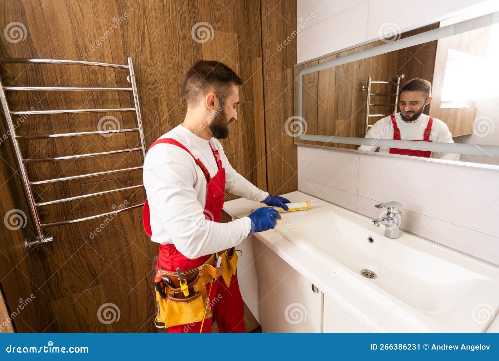 A Worker Installs a Wash Basin in a Bathroom. Stock Image - Image of ...