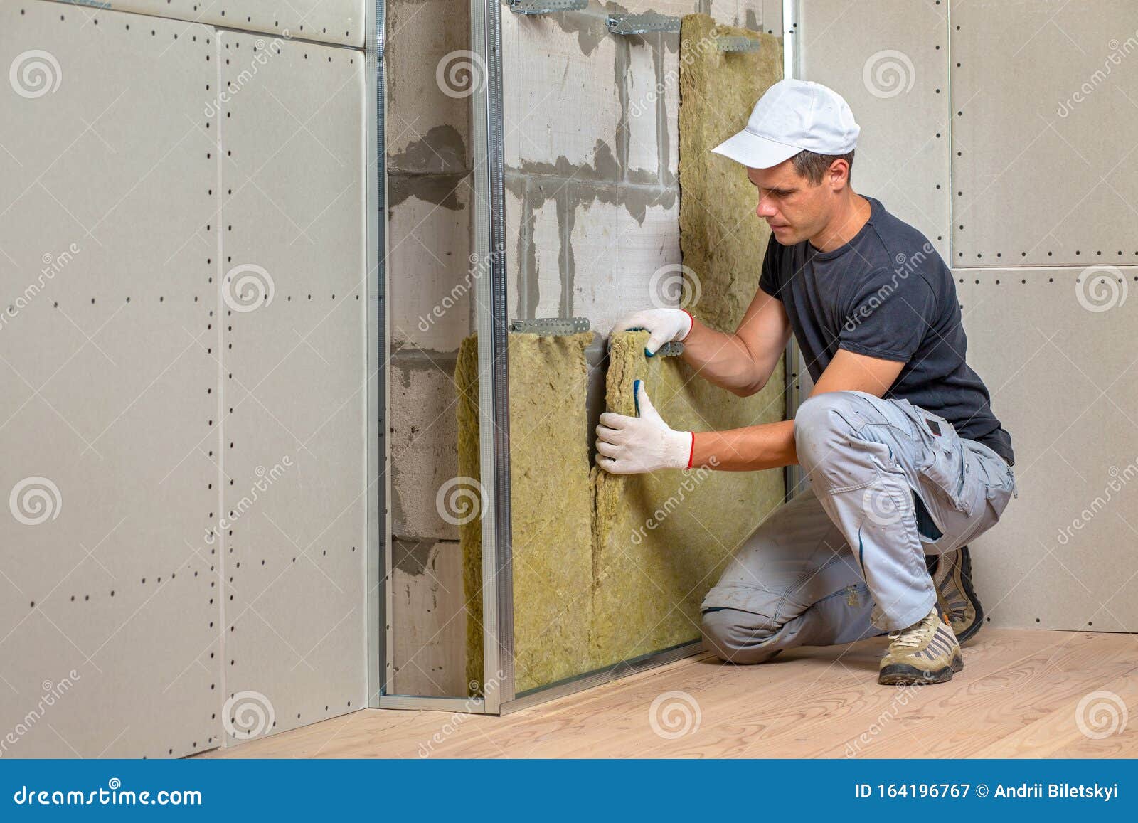 Worker Insulating a Room Wall with Mineral Rock Wool Thermal Insulation ...