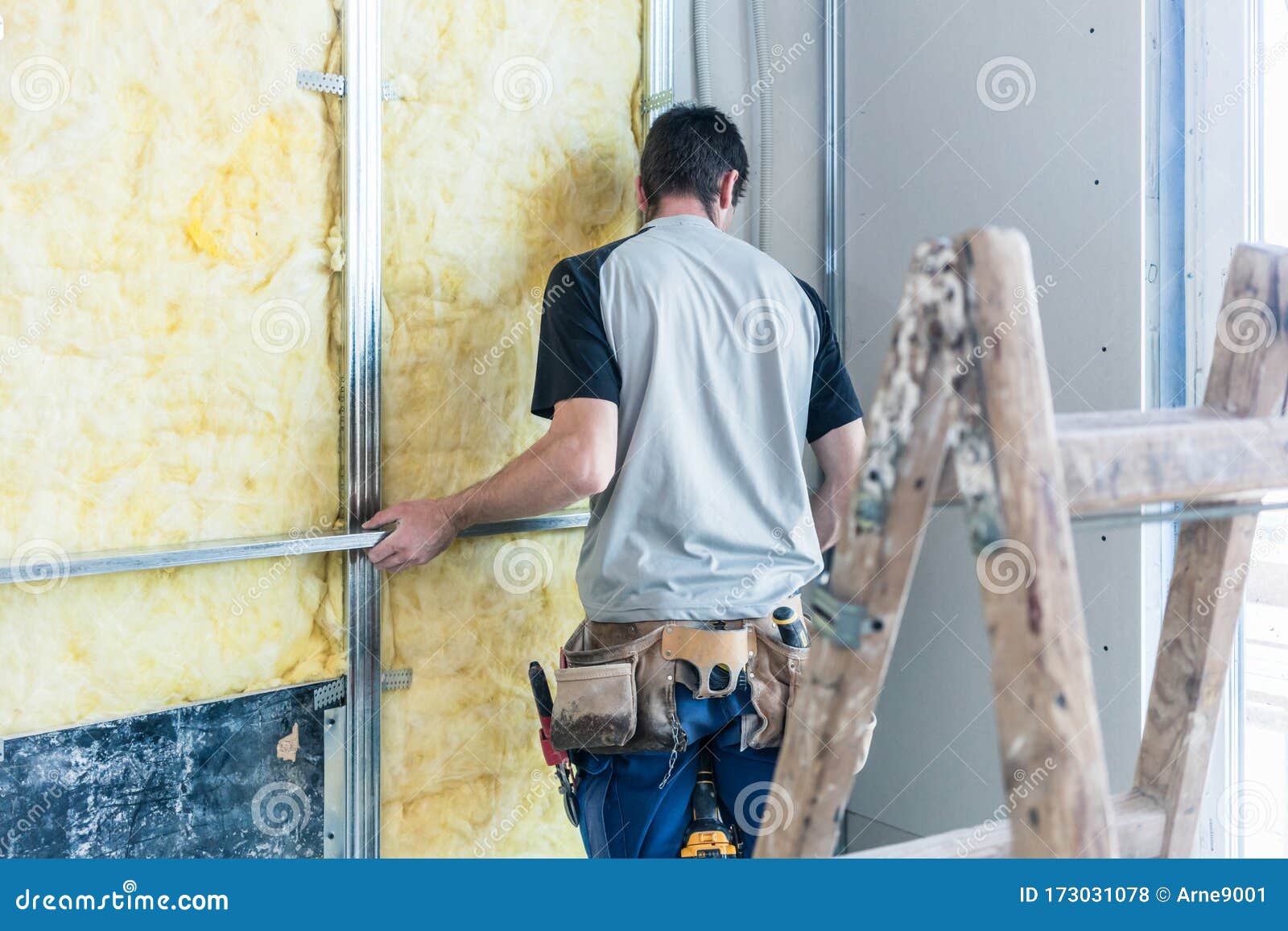 Worker Insulating Wall of a New Building on Construction Site Stock ...