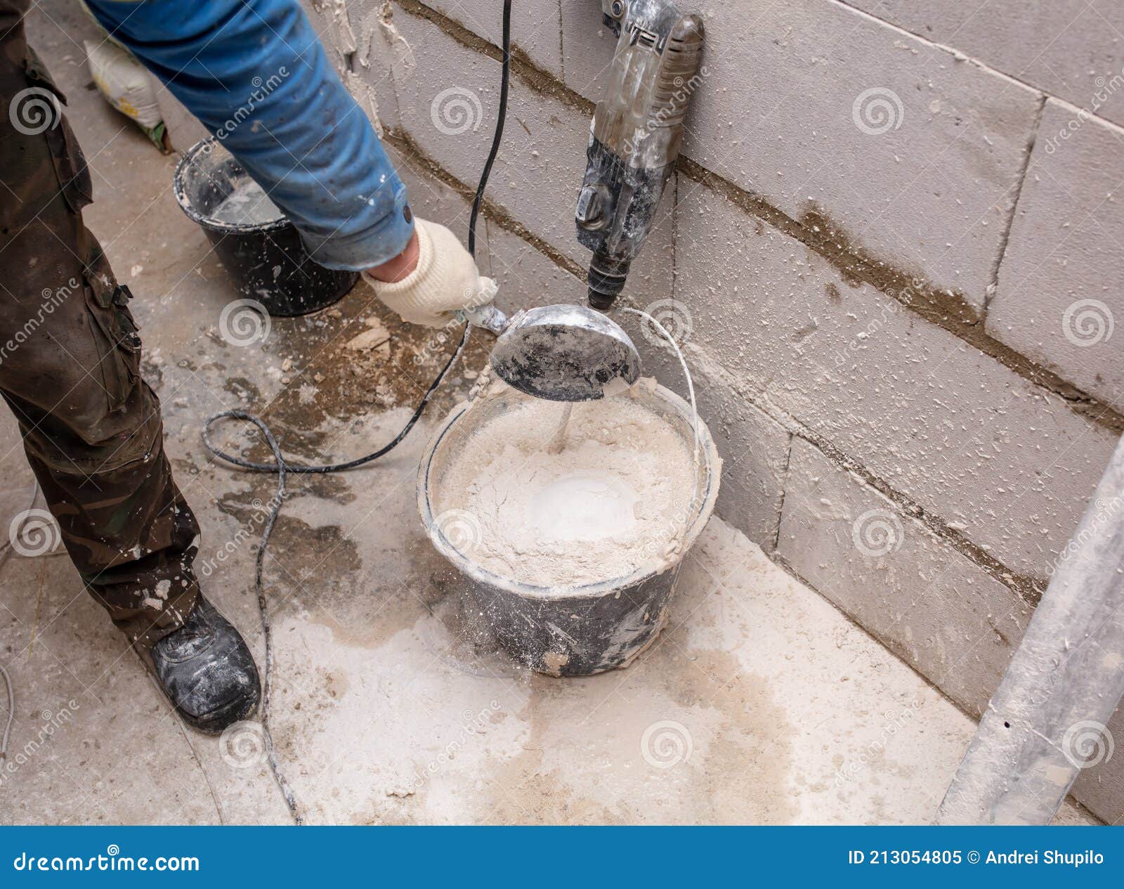 A Worker Kneads the Mixture into Plaster Buckets. Home Renovation Stock ...