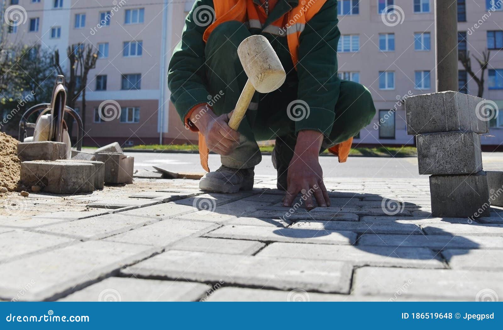 A Worker Knocks a Hammer on the Paving Slabs. Stock Photo - Image of ...