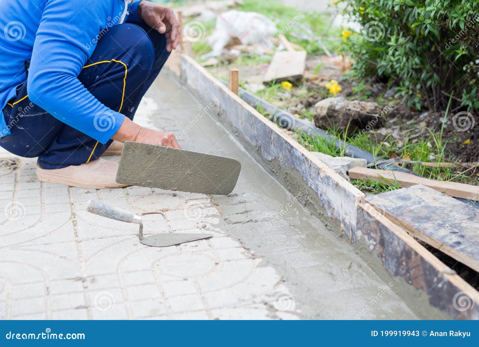 Worker, Labor or Mason is Sitting and Repairing or Constructing Walkway ...