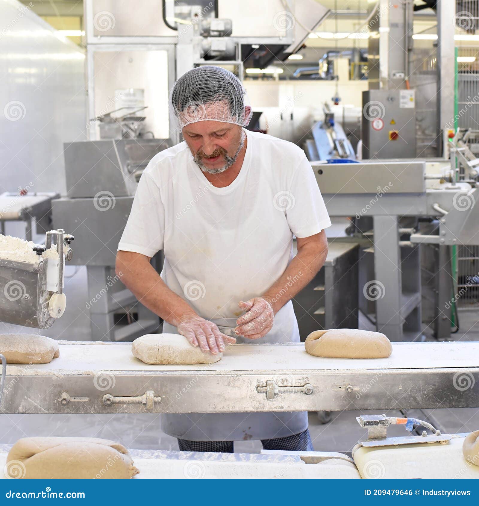 Worker in a Large Bakery - Industrial Production of Bakery Products on ...