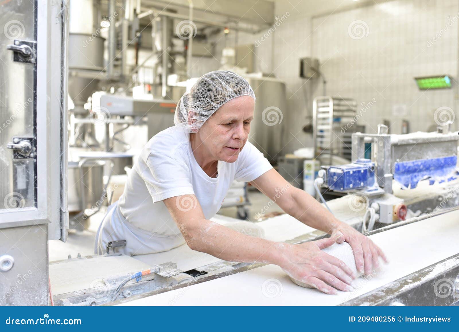 Worker in a Large Bakery - Industrial Production of Bakery Products on ...