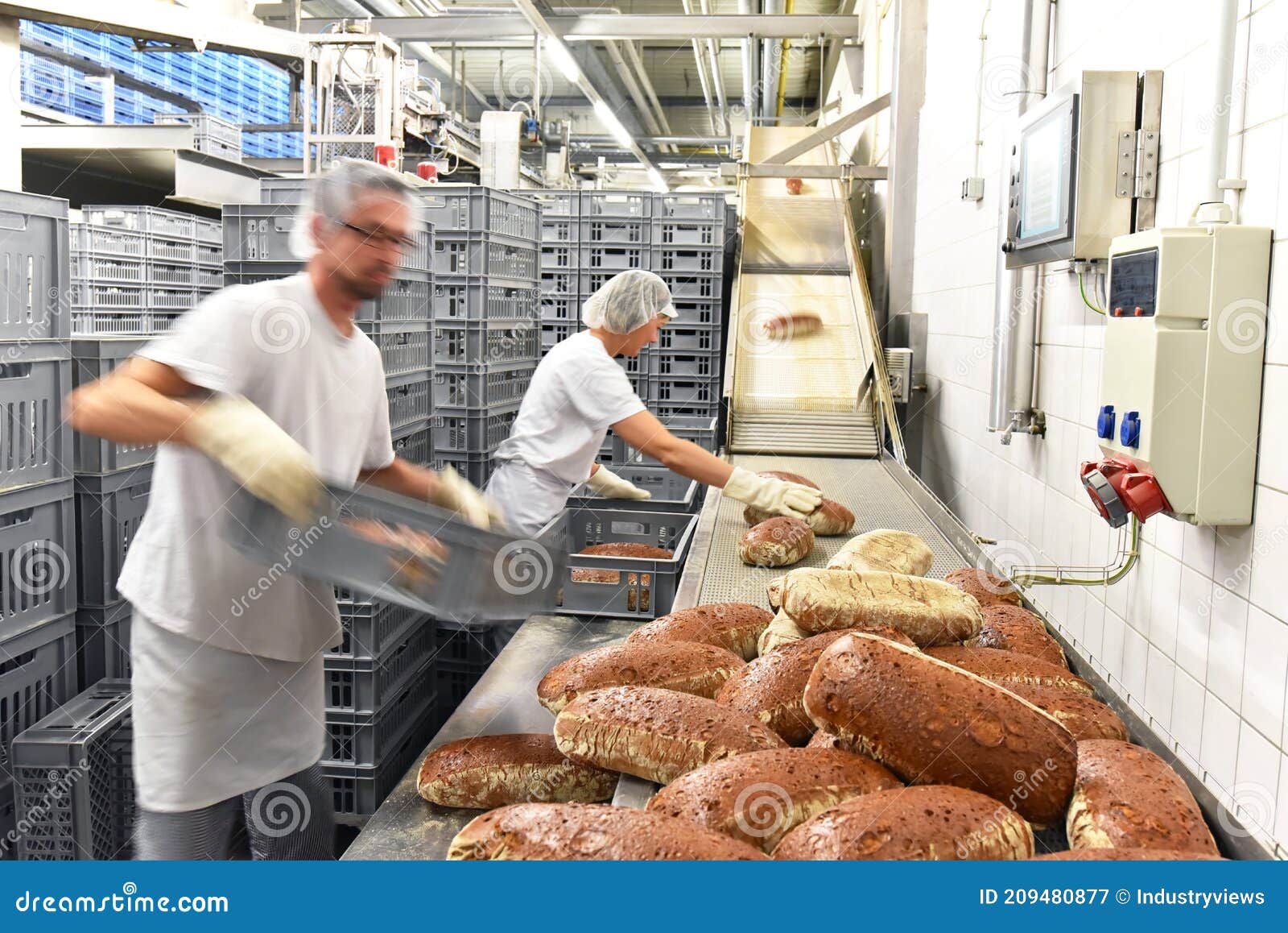 Worker in a Large Bakery - Industrial Production of Bakery Products on ...