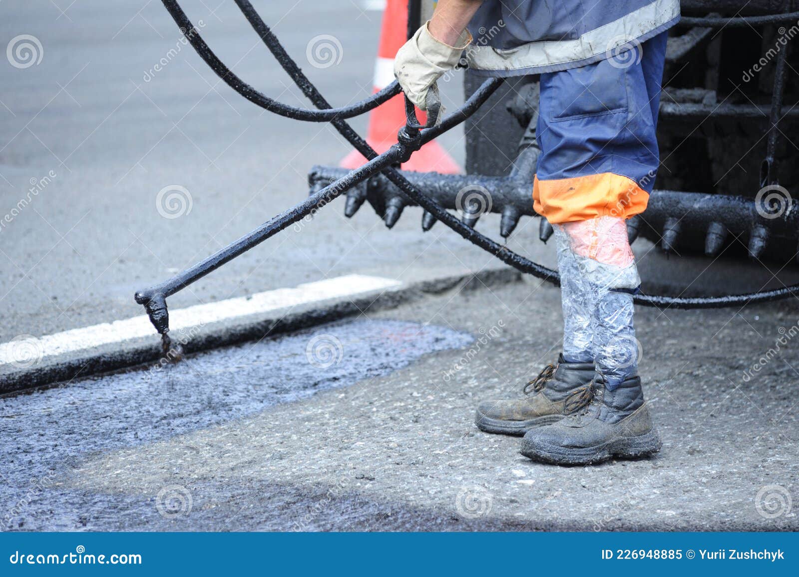 Worker Lay Bitumen Using Tar Sprayer, Standing in Front of a Bitumen ...