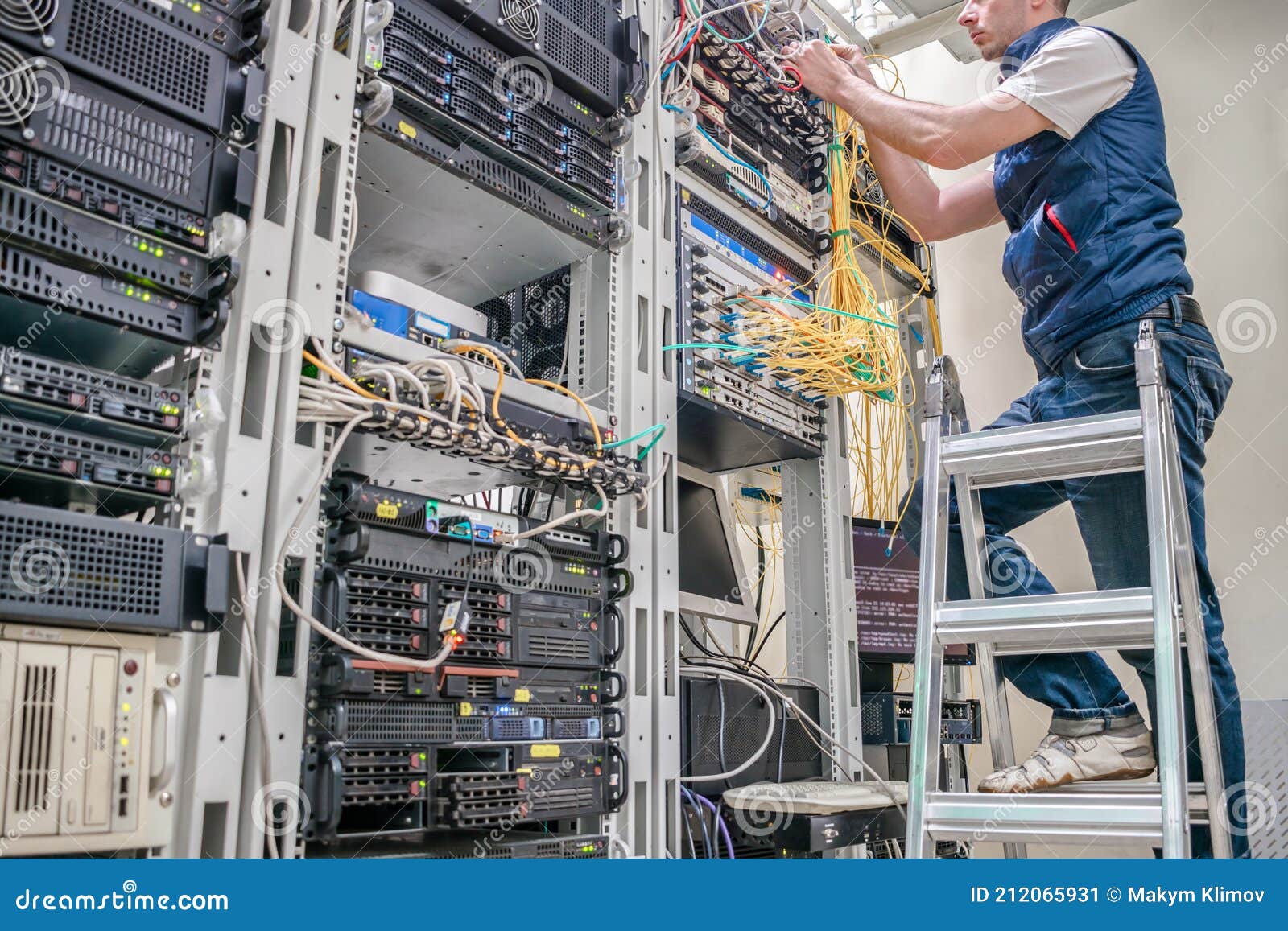 A Technician Lays Wires In The Server Room Of A Data Center. The ...