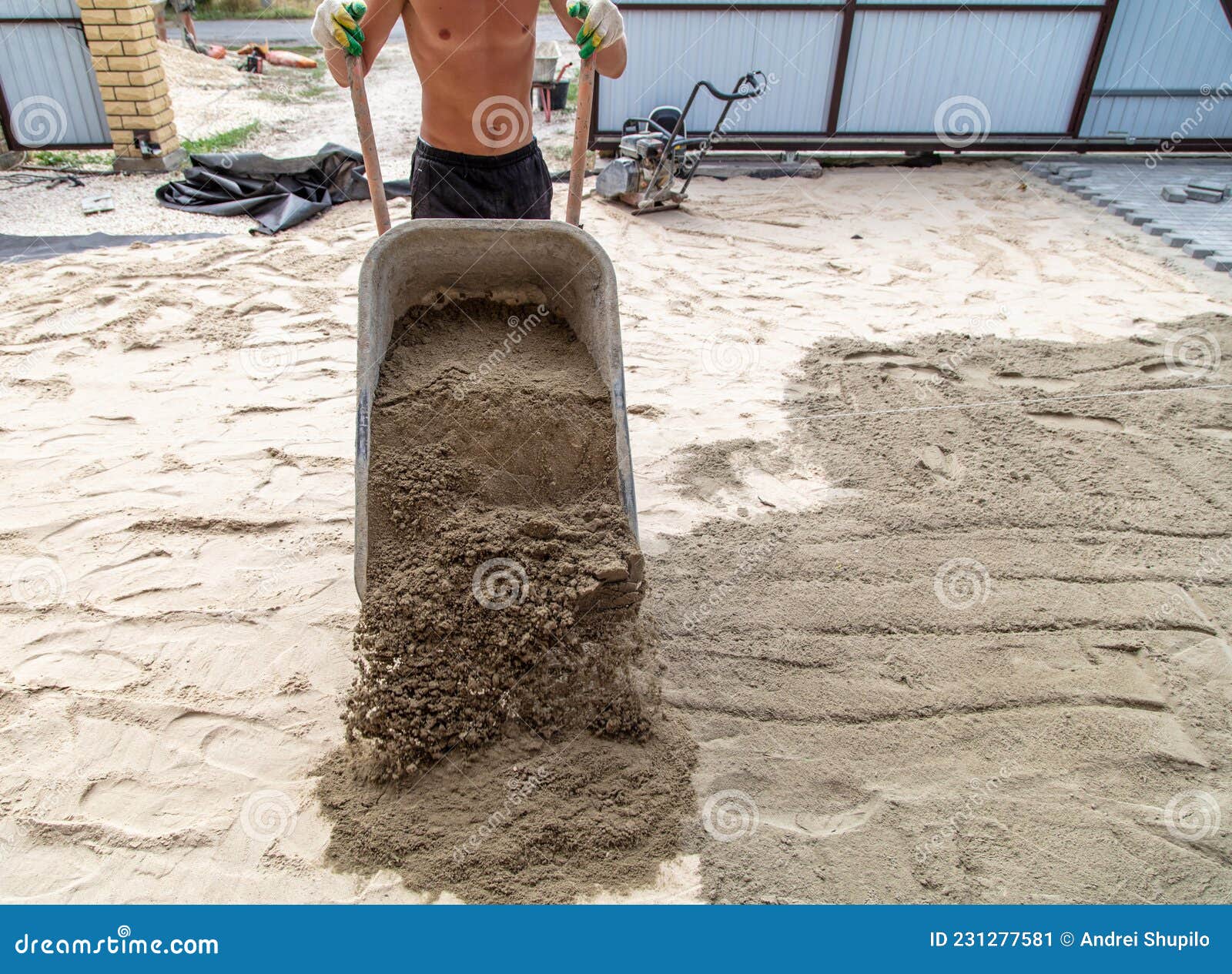 A Worker Lays Down Sand for Paving Slabs. Stock Image - Image of ...