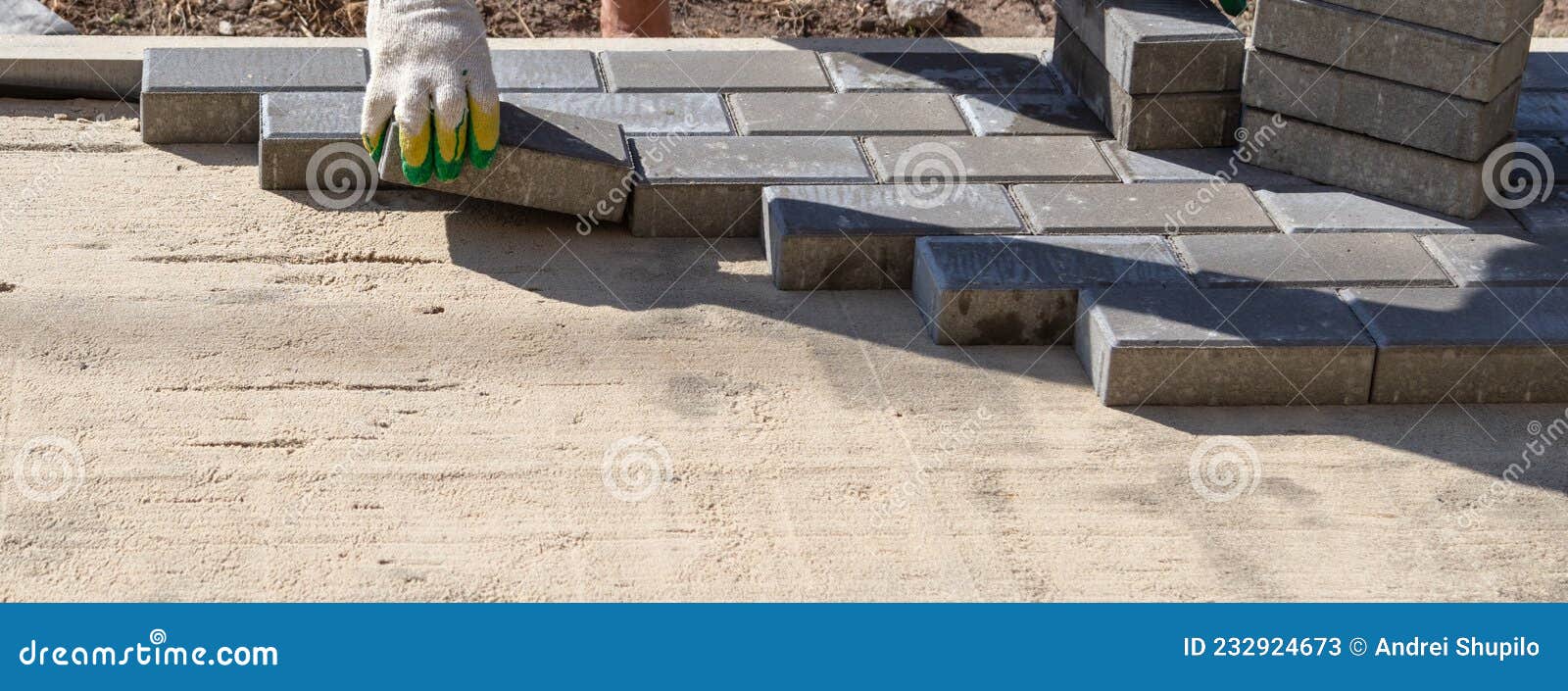 A worker lays paving slabs stock image. Image of work - 232924673