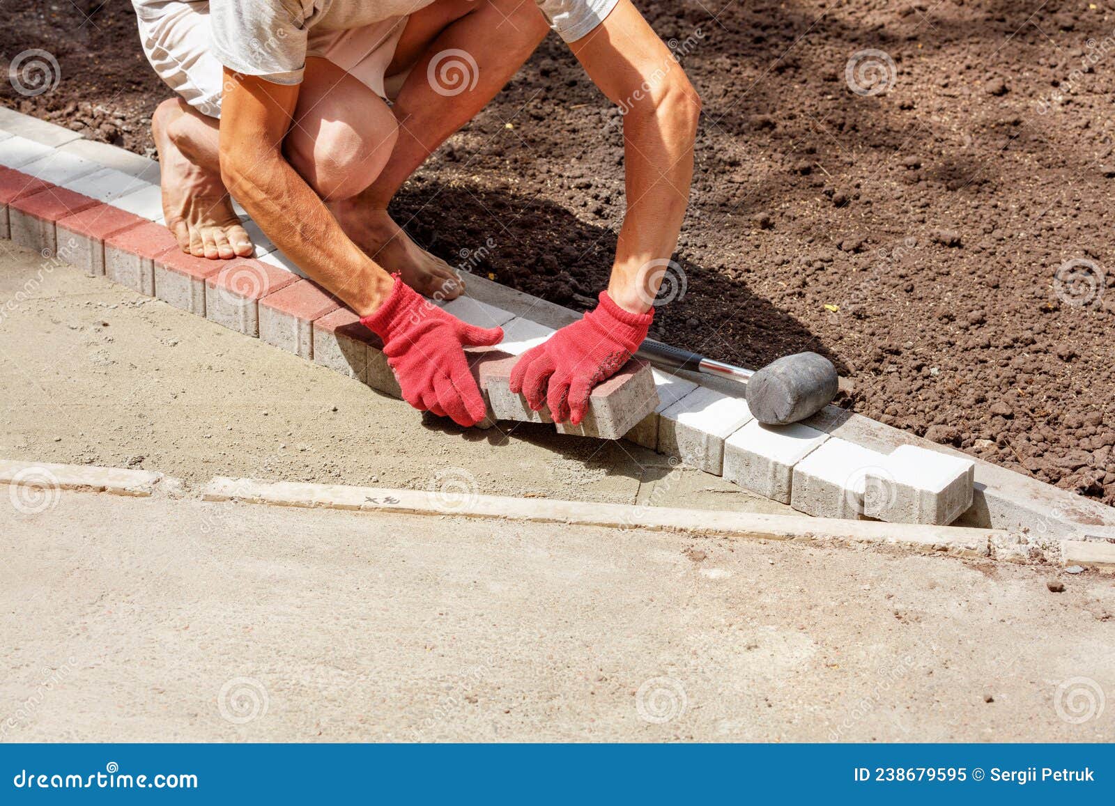A Worker Lays Paving Slabs on a Park Path on a Bright Sunny Day Stock ...