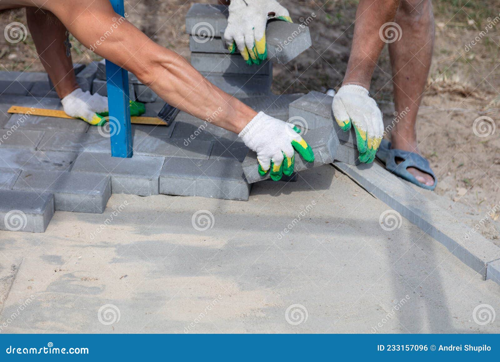 A worker lays paving slabs stock photo. Image of mason - 233157096