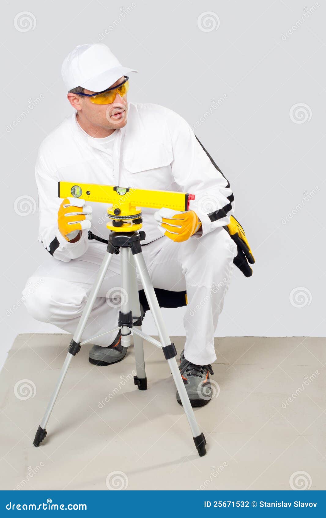 Worker Level Measured with a Laser Level Stock Photo - Image of grout ...