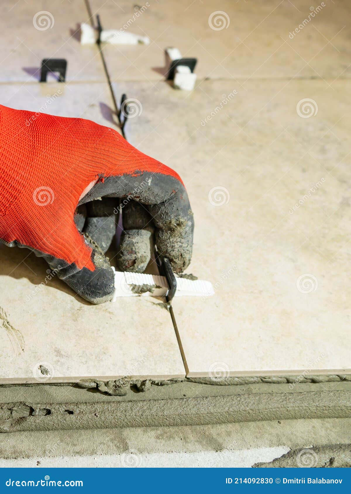 Workers are Using Plastic Clamps and Wedges To Leveling the Ceramic ...