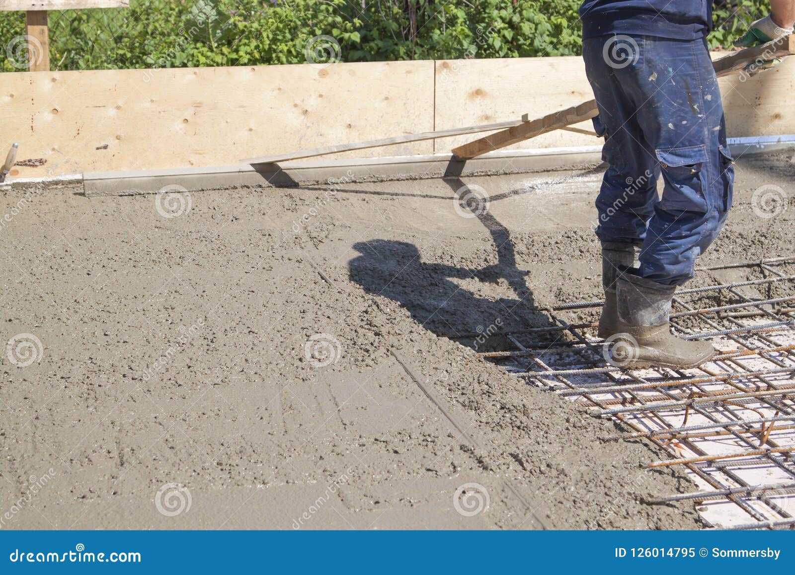 Worker Leveling With Wooden Trowel The Fresh Poured Concrete Or Cement ...