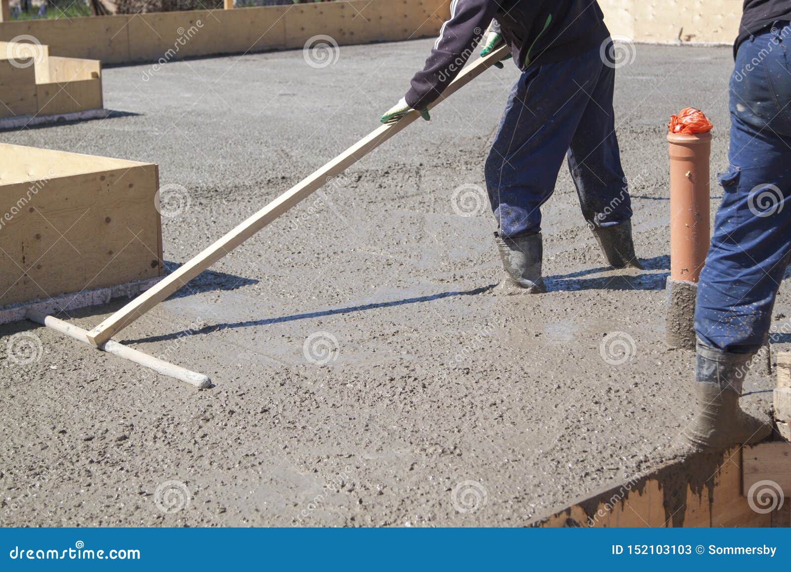 Worker Leveling Fresh Concrete Slab with a Special Working Tool ...