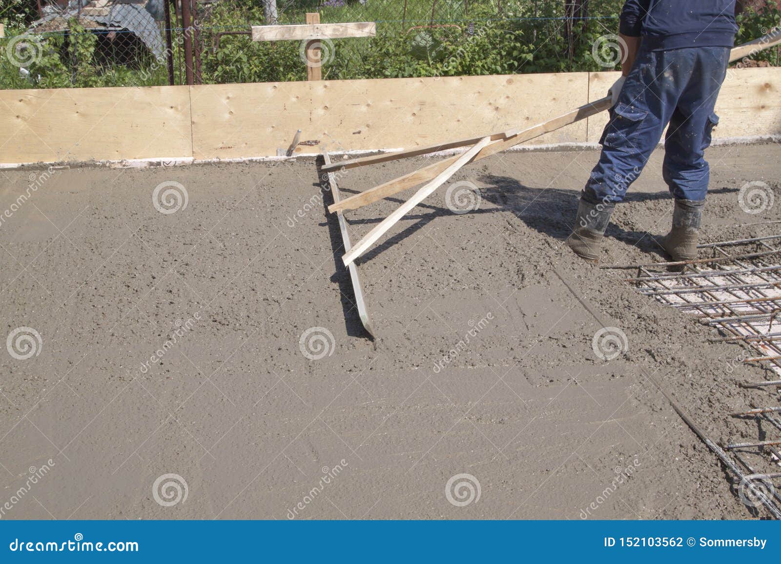 Worker Leveling Fresh Concrete Slab with a Special Working Tool Stock ...