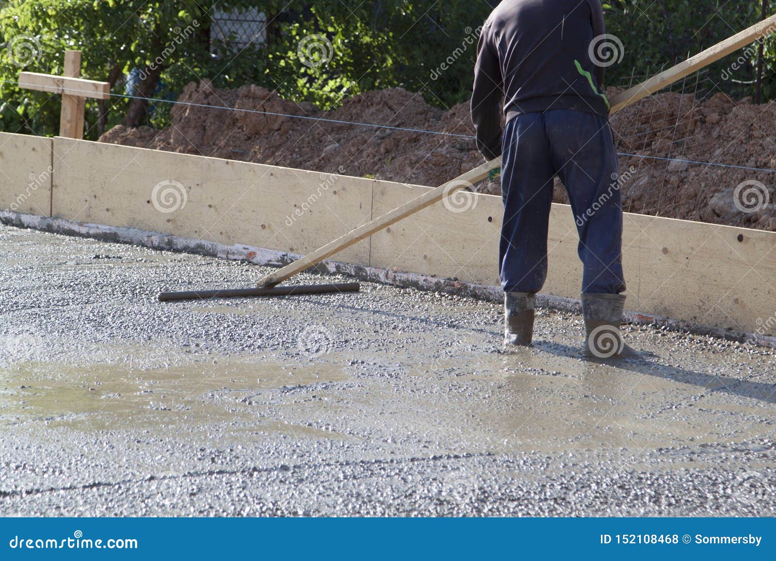 Worker Leveling Fresh Concrete Slab with a Special Working Tool Stock ...